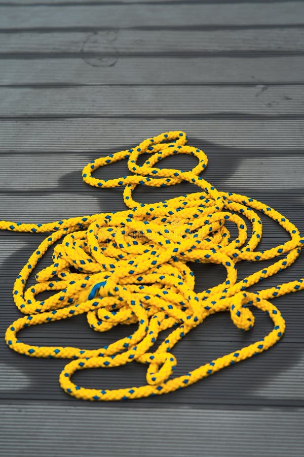 Tangle Wet Yellow Rope on a Deck Stock Photo - Image of knot, planks ...