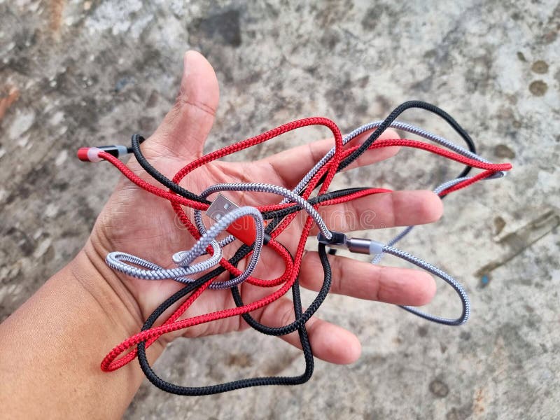 Tangled Cell Phone Charger Cable in the Hand Stock Photo - Image of ...