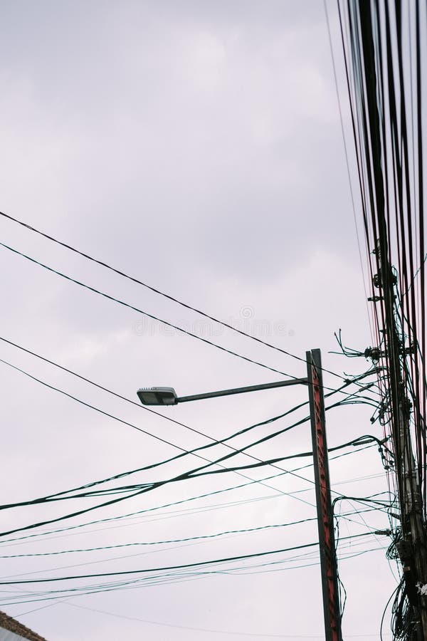 Tangled Electrical Cables Hanging Overhead, Creating a Chaotic yet ...