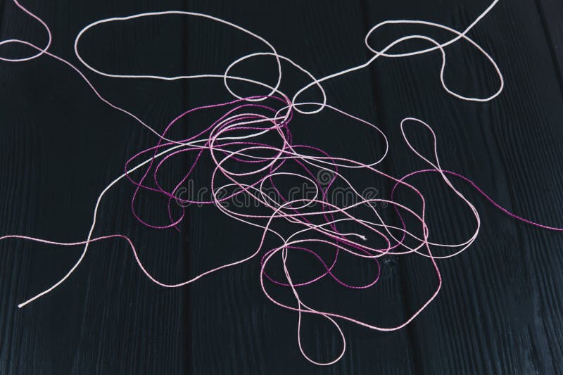 Tangled Multi-colored Threads Lie on Black Wooden Boards. Threads for ...