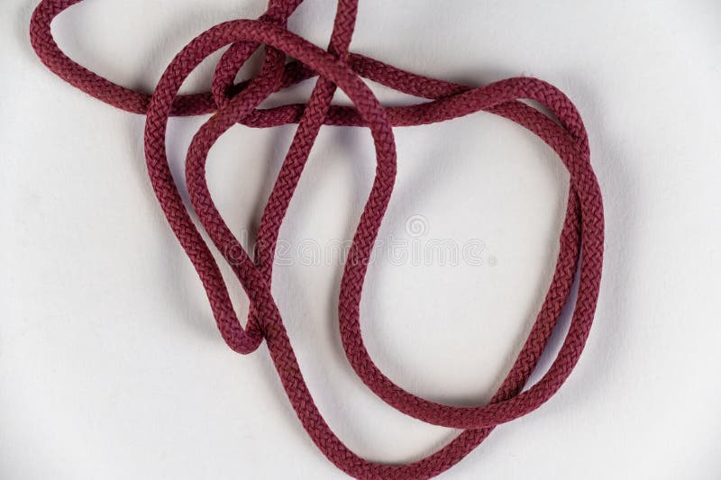 A Tangled Red Rope Against a Neutral Background. Round Rope without ...