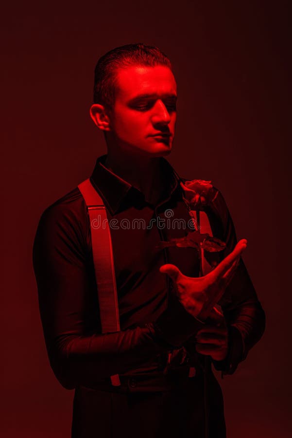 Tango Dancer Holding Red Rose on Dark Background with Red Lighting ...