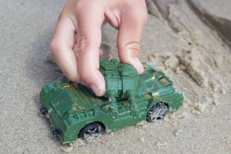 Tank toy in sand stock image. Image of playful, activity - 83754943