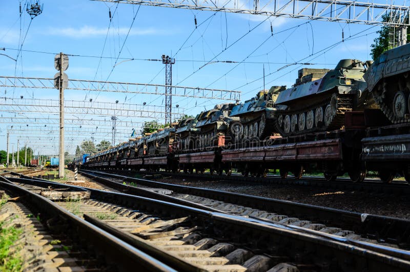 Cargo Train Carrying Military Equipment and Military Armed Tanks on a ...