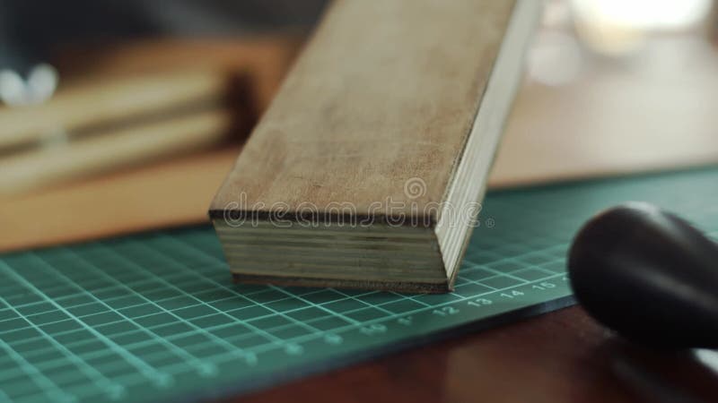 A Tanner Sharpens a Stencil Knife on a Leather Sharpener. the ...