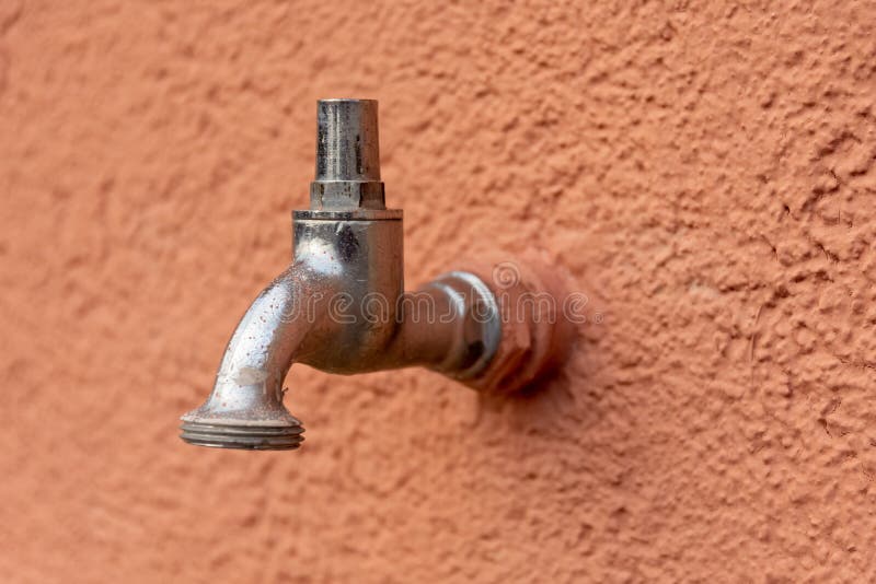 A tap on a red house wall stock image. Image of clean - 169096217