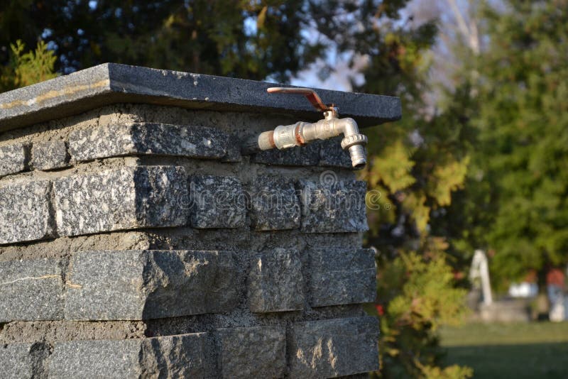The tap on the stone well stock image. Image of country - 40733077