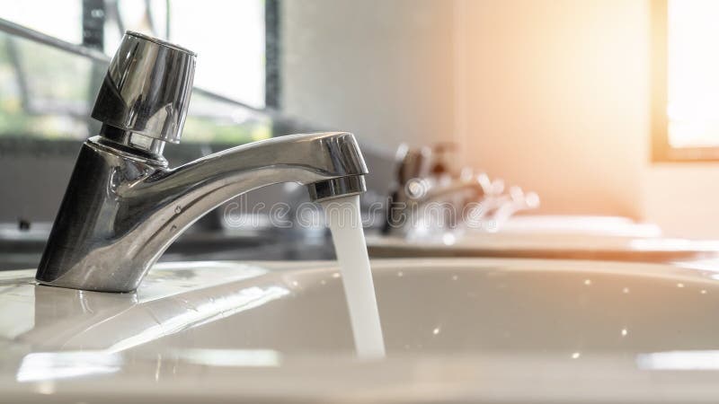 Tap Water Running Wastage From Faucet Over Hand Washing Sink Ceramic