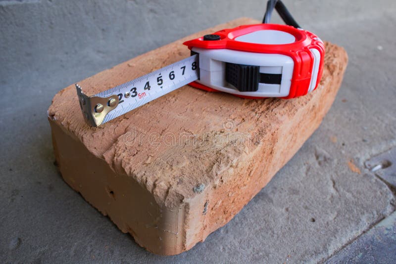 Tape Measure is on the Brick Stock Photo - Image of occupation, home ...