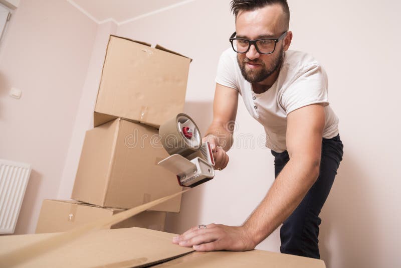 Taping Up Boxes stock photo. Image of beautiful, couple - 5343950