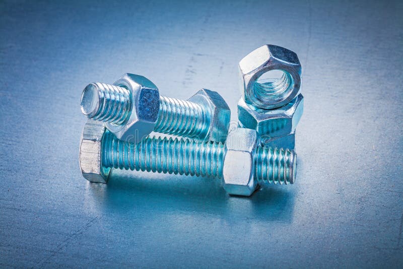 Tapped Nuts and Bolts on Metallic Background Stock Photo - Image of ...
