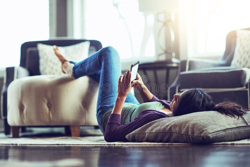 Tapping into the Weekend. a Young Woman Using a Mobile Phone while ...