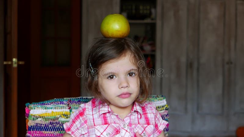 Target Concept - Girl Sitting with Apple on Head and Then Drops it ...