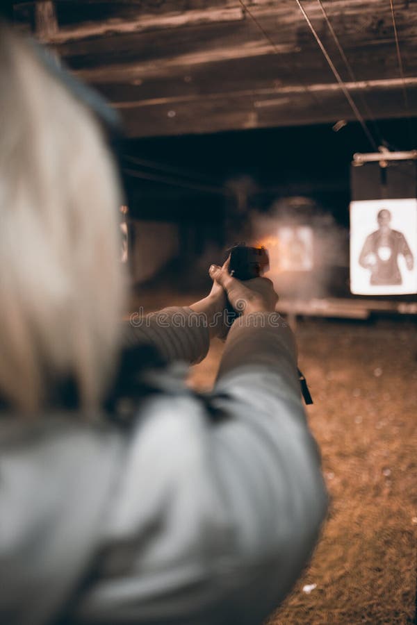 Woman Shooting with Gun at Target in Shooting Range Stock Photo - Image ...