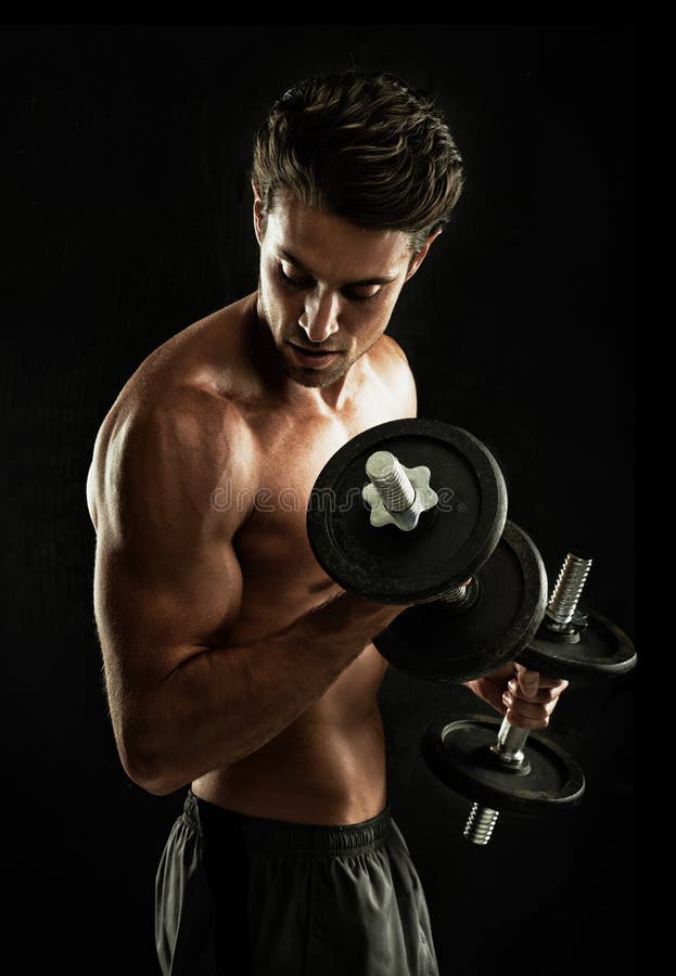 Targeting His Biceps. Young Man Isolated on Black Performing Bicep ...