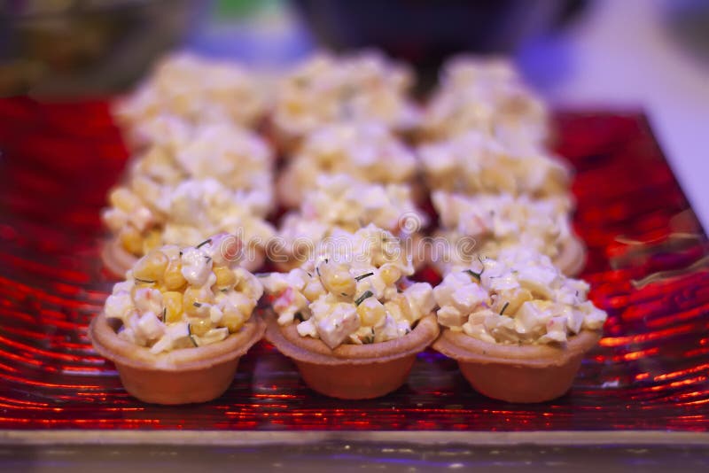 Tartlets with Corn and Crab Salad on Red Plate Stock Image - Image of ...