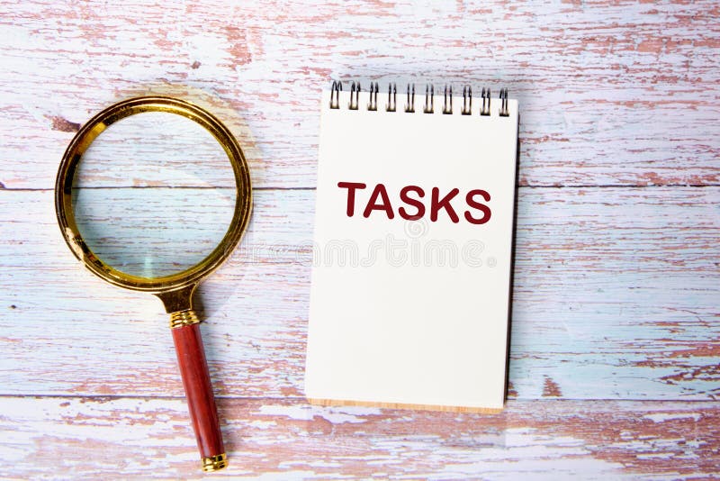 Task Text Written on a Notebook Lying on the Table Next To the ...