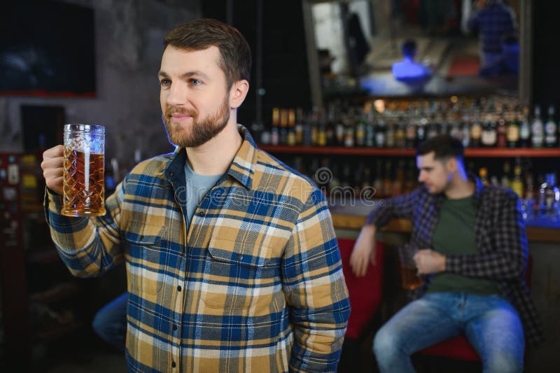 Tasting a Good Beer. Portrait of Thoughtful Men Drinking Beer at the Bar Stock Image - Image of ...
