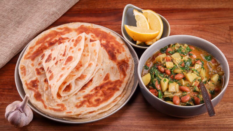 African Chapati and Bean Stew Served with Garlic and Lemons Stock Photo ...