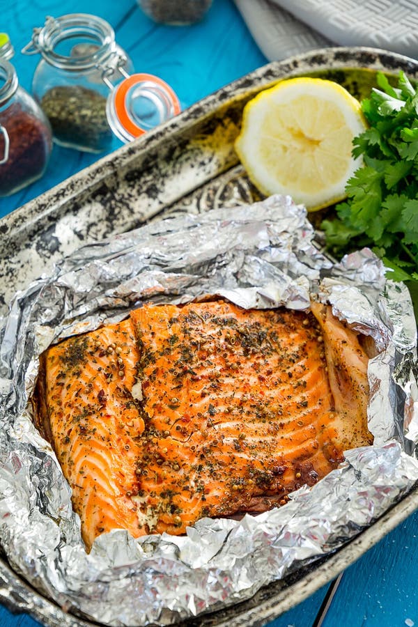 Tasty Baked Fish Salmon in Foil on Blue Table, Top View Stock Photo ...
