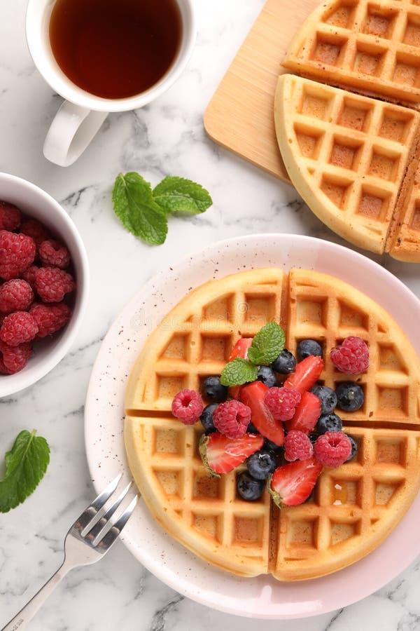 Tasty Belgian Waffles with Fresh Berries Served on White Marble Table ...