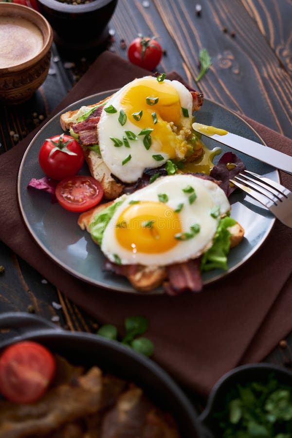 Tasty Breakfast - Fried Egg Toasts, Bacon, Tomatoes on Wooden Kitchen ...