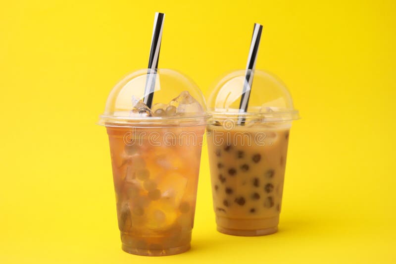 Tasty Bubble Tea in Plastic Cups on Yellow Background Stock Image ...