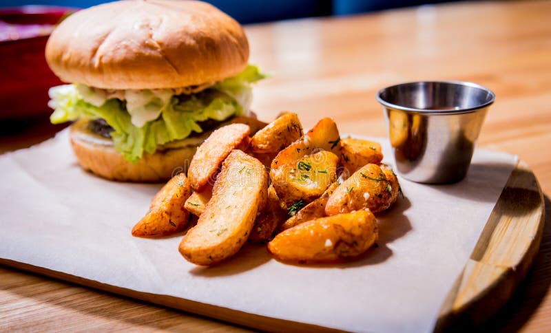 Tasty Cheeseburger and Chips on the Wooden Table. Restaurant Stock ...