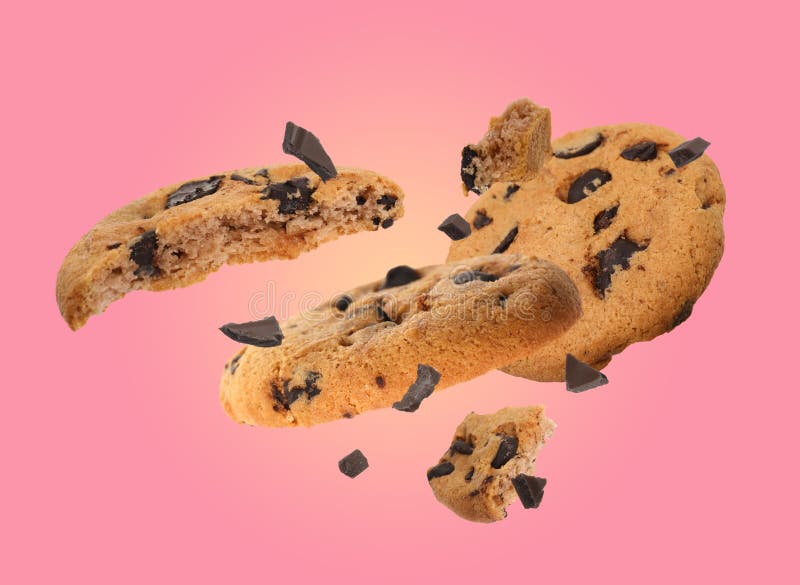 Tasty Chocolate Chip Cookies Falling on Pink Background Stock ...