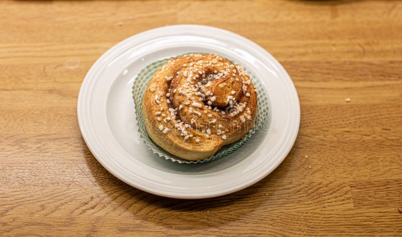 Tasty Cinnamon Bun on a Plate Stock Photo - Image of spice, roll: 170641890
