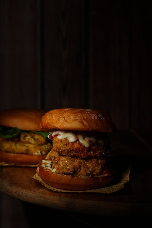 Classical Burgers on Wooden Table with Dark Background Stock Photo ...