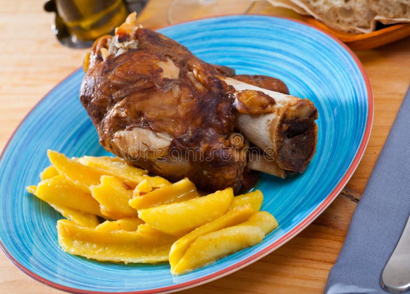 Tasty Cooked Baked Pork Knuckle with Potatoes on Plate Stock Image ...