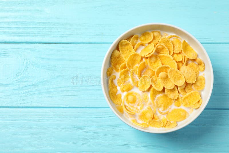 Tasty Crispy Corn Flakes with Milk on Blue Wooden Table, Top View ...
