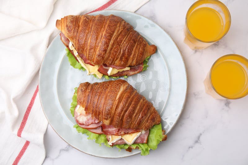 Tasty Croissants with Brie Cheese, Ham and Bacon on White Marble Table ...