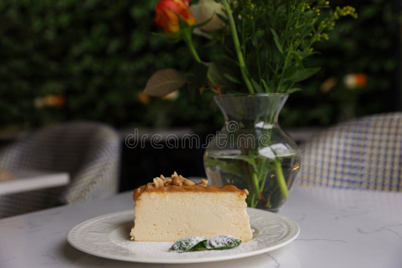 Tasty Dessert and Vase with Flowers on White Table in Cafeteria Stock ...