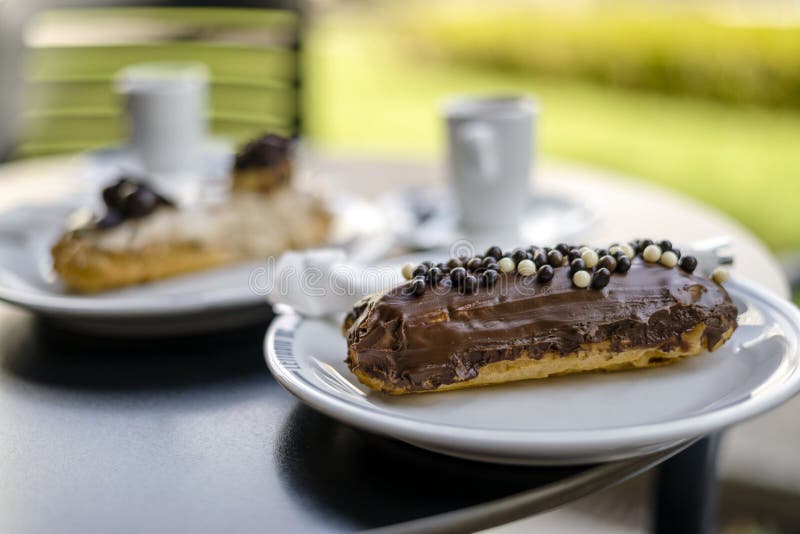 Tasty Eclair Pastry Filled and Covered with Chocolate Stock Image ...