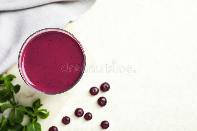 Tasty Fresh Acai Juice in Glass on Light Table, Top View. Space for ...
