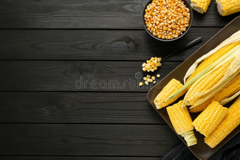 Tasty Fresh Corn Cobs and Kernels on Black Wooden Table, Flat Lay ...