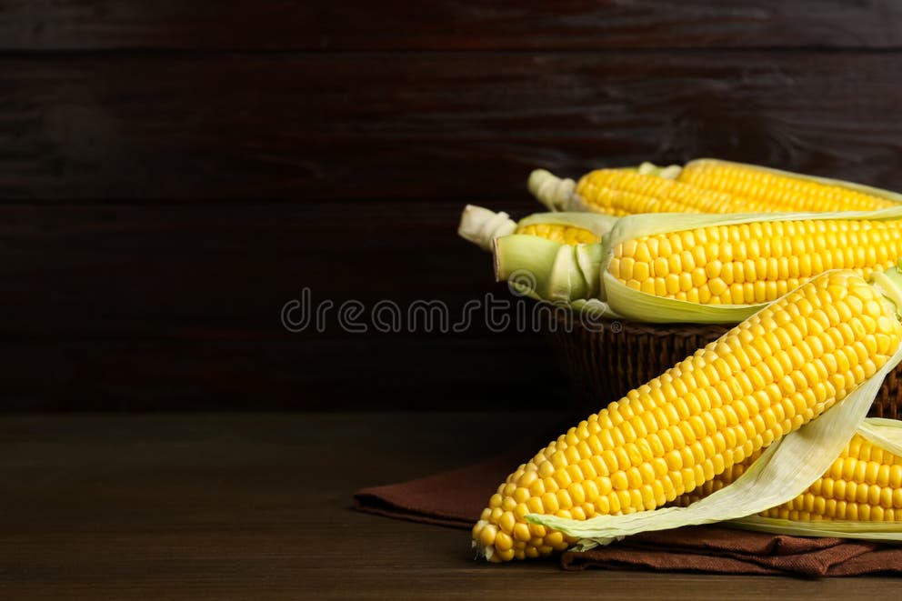 Tasty Fresh Corn Cobs on Wooden Table, Space for Text Stock Photo ...