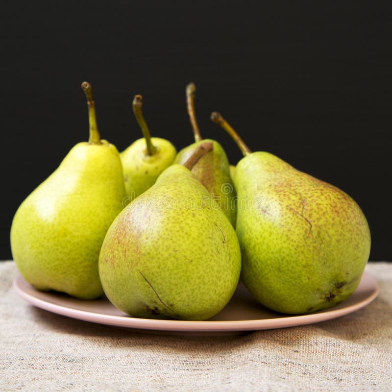 Tasty Fresh Pears On Pink Plate Against Black Background, Side View ...