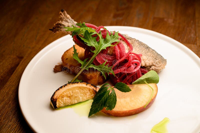 Tasty Fried Fish Garnished with Onion and Lemon and Toast on Plate on ...