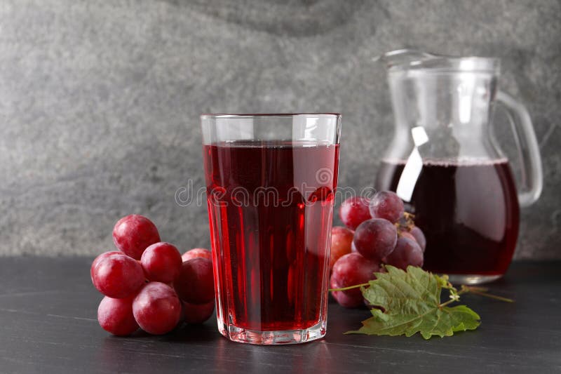 Tasty Grape Juice, Leaf and Berries on Dark Textured Table Stock Photo ...