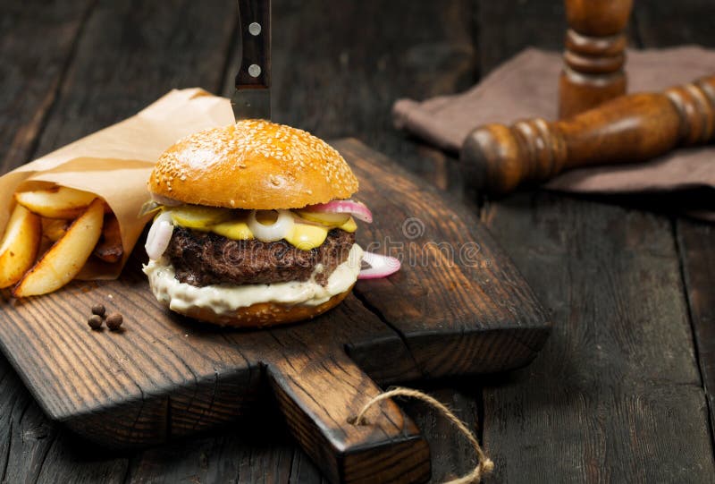 Tasty Grilled Beef Burger with Potatoes on Rustic Wooden Table Stock ...