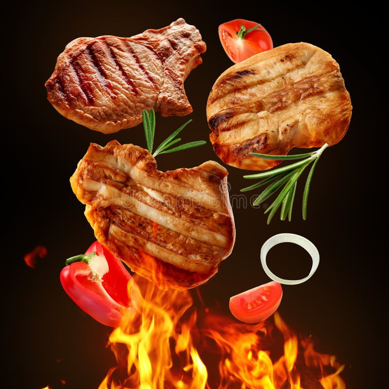Tasty Grilled Meat, Different Vegetables and Fire Flame on Dark ...