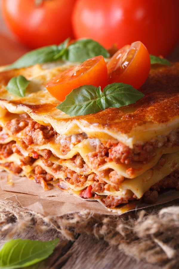Tasty Lasagna with Basil and Tomatoes on an Old Table, Vertical Stock ...