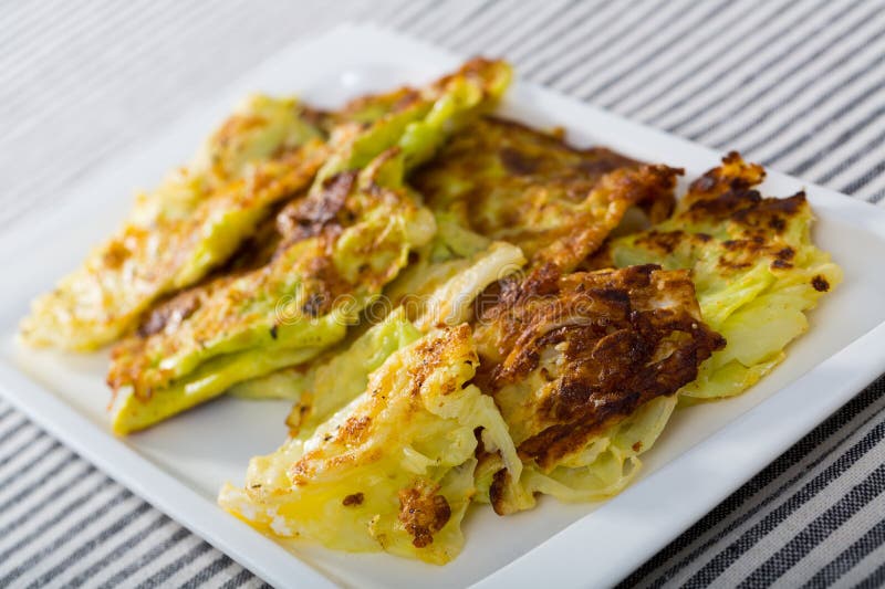 Tasty Leaves of Cabbage in Batter on a Plate at Table Stock Photo ...