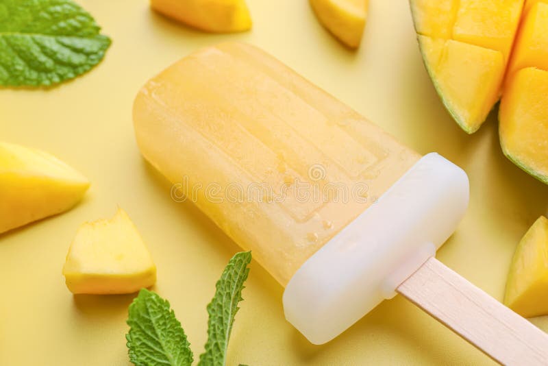 Tasty Mango Ice Pop on Light Yellow Background, Closeup. Fruit Popsicle ...