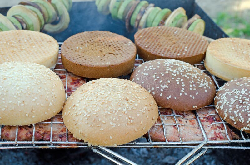 Tasty Meat with Buns on Grill Stock Photo - Image of grilled, barbecue ...
