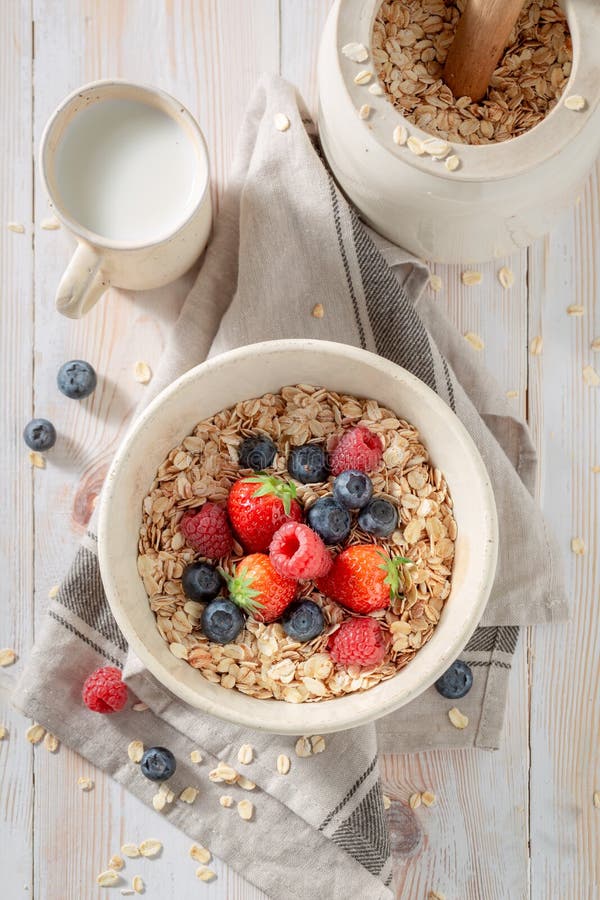Tasty Oat Flakes with Fruits for Breakfast on White Table Stock Image ...