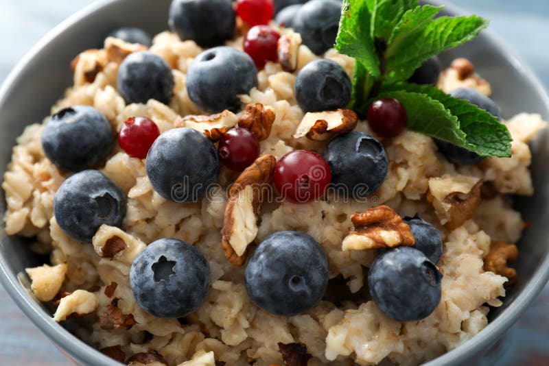 Tasty Oatmeal with Fresh Berries and Nuts, Closeup Stock Photo - Image ...
